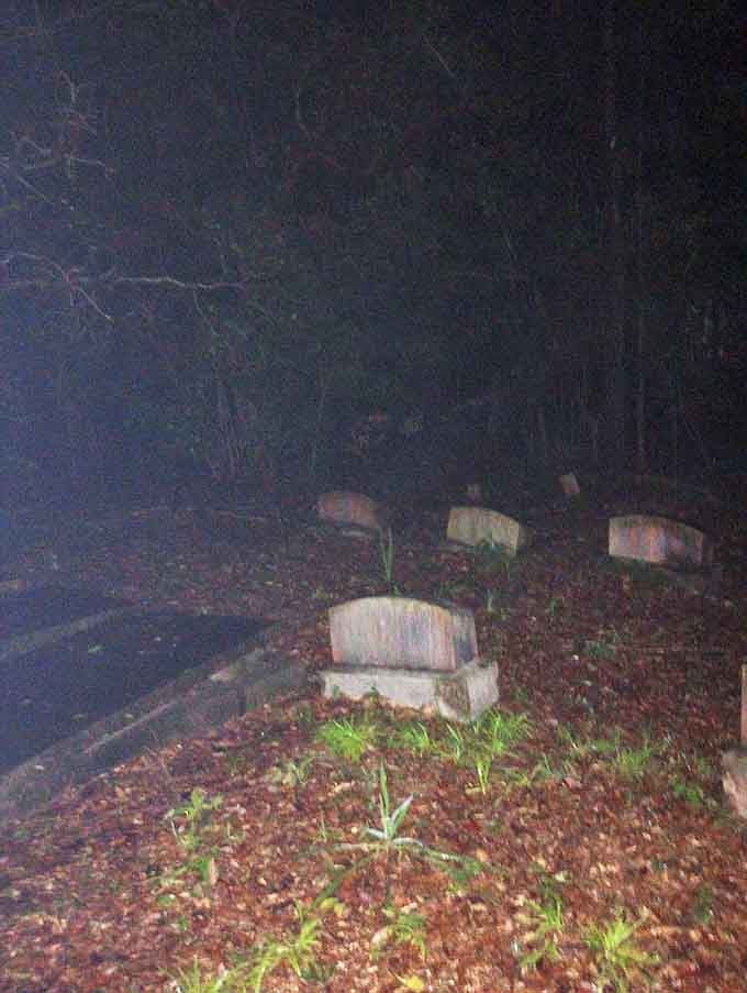 Night transforms simple headstones into mysterious markers, their inscriptions hidden until brave souls venture closer with lanterns.