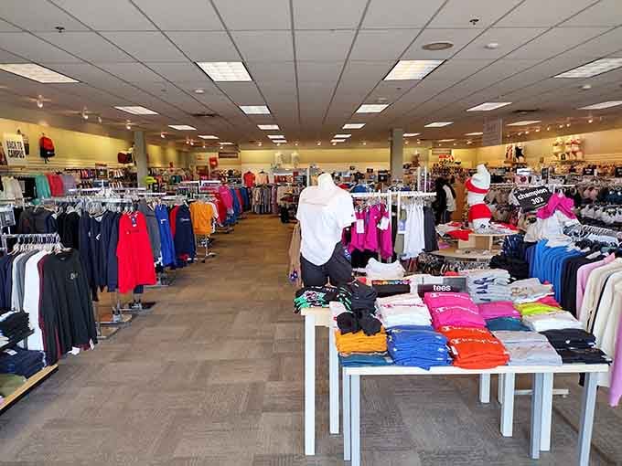 Racks on racks of possibilities, organized by color like a retail rainbow of second chances.