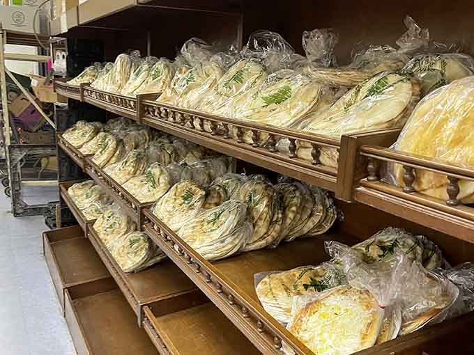 Fresh pita bread stacked like edible clouds, soft enough to make store-bought versions retire in shame and embarrassment.