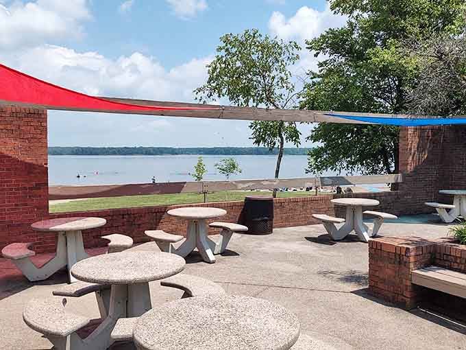 Shaded picnic tables with lake views offer the perfect spot for sandwiches that somehow taste better near water.