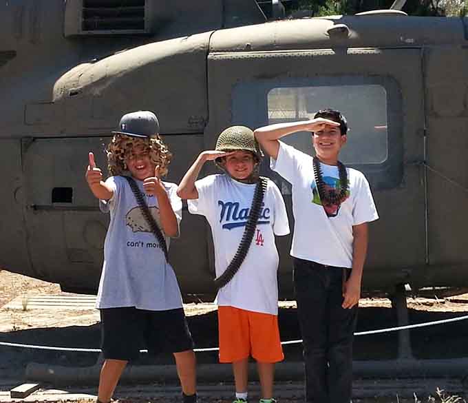 These young recruits salute history with genuine enthusiasm, making every veteran smile at their spirited patriotic display.