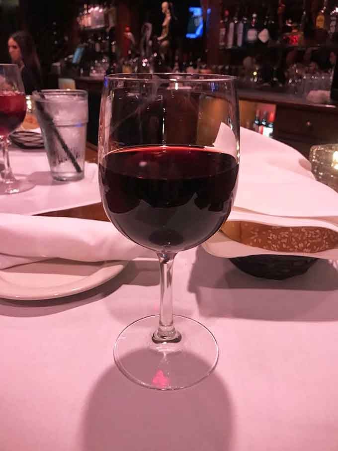 A beautiful glass of red wine catching the light, ready to make any meal feel like a celebration.