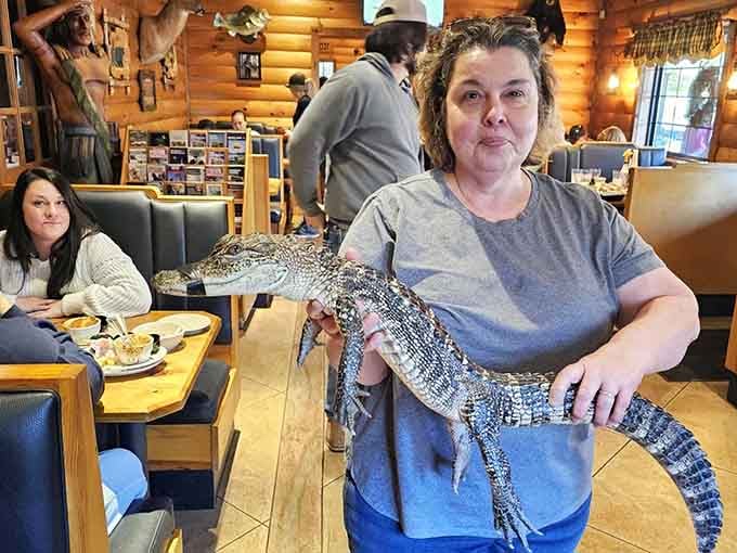 Yes, that's a real alligator being held inside the restaurant, because apparently normal dinner entertainment wasn't exciting enough.