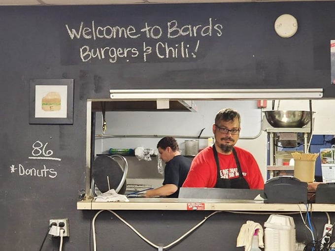 Behind that window, culinary wizards craft burgers that defy gravity and common sense with equal enthusiasm daily.