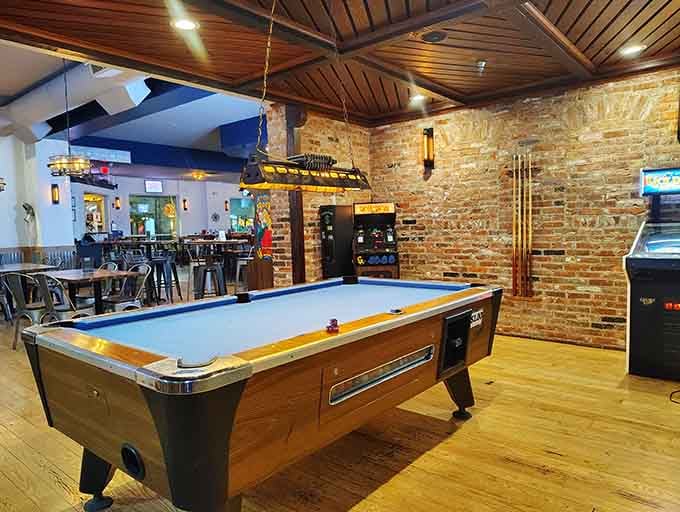 A pool table waits patiently for players who need a break from digital entertainment for analog fun.