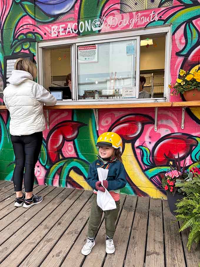 The window to happiness opens daily, framed by murals that make waiting in line feel like gallery browsing.