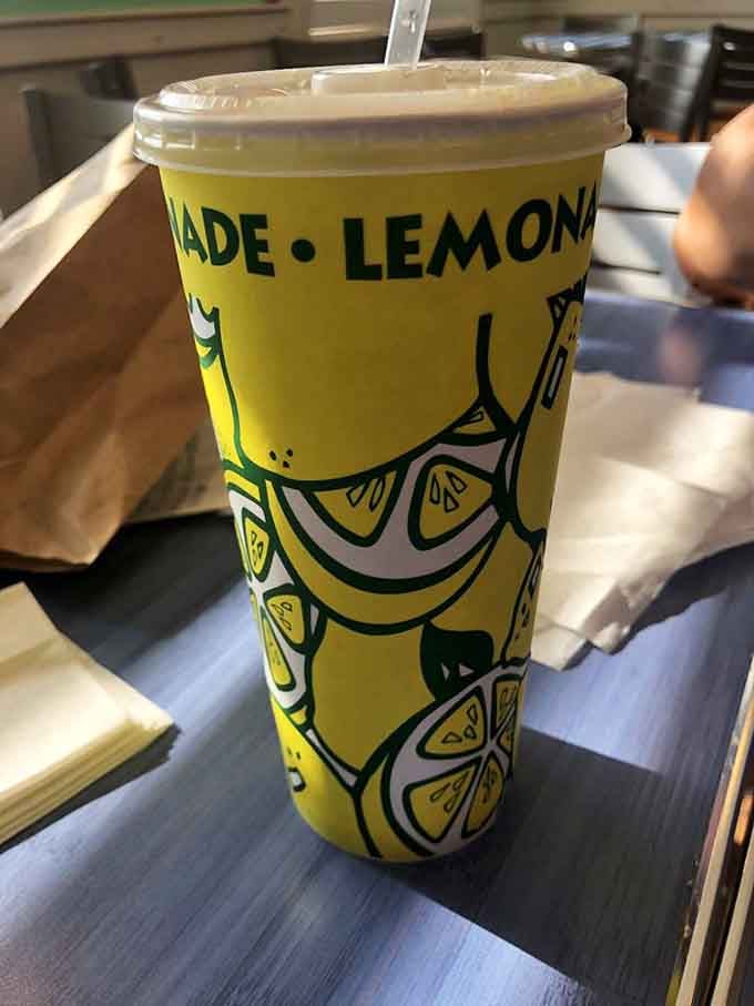 Fresh-squeezed lemonade in a cheerful cup promises the perfect sweet-tart refreshment for any meal here.