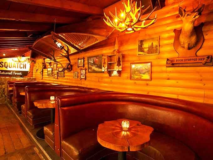 Curved booth seating under antler chandeliers offers the perfect spot for plotting adventures or avoiding your responsibilities entirely.