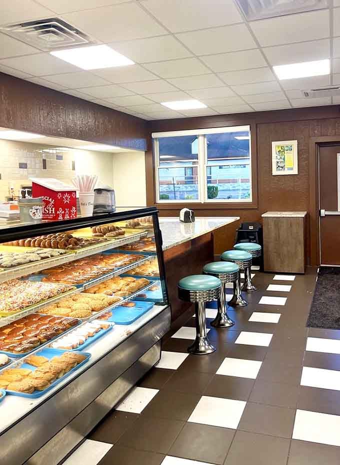 Counter seating with a view of fresh donuts is basically the best theater experience money can buy.