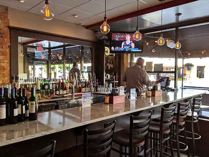 The polished bar beckons with top-shelf spirits and enough seating to make happy hour genuinely happy for everyone.
