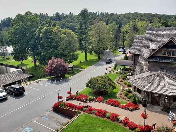 Red blooms frame the entrance like nature's own welcome mat, because first impressions matter even in the mountains.