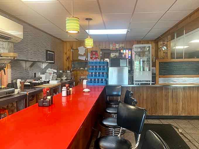 The red countertop gleams like a beacon, inviting solo diners to pull up a stool and stay awhile.