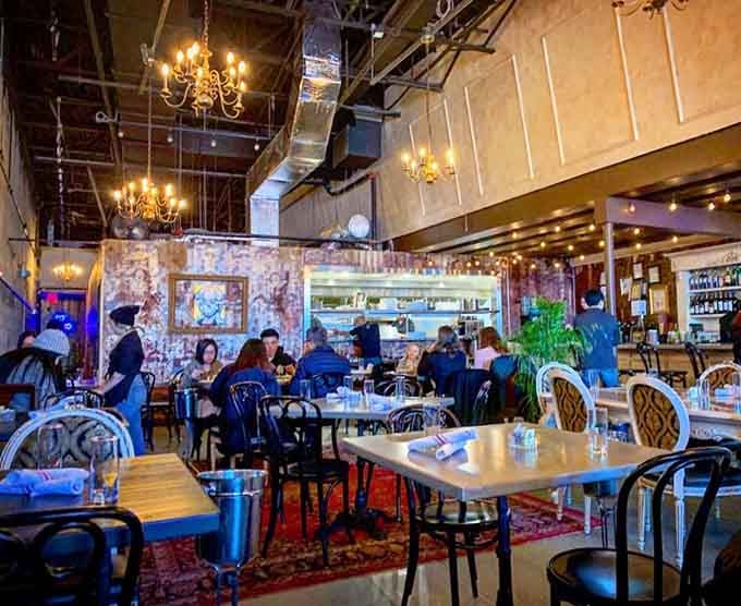 Diners enjoying the lively buzz under those signature chandeliers, where good food brings strangers together naturally.