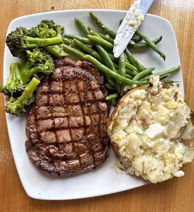 Ribeye with green beans and mashed potatoes is the steakhouse classic that never goes out of style.