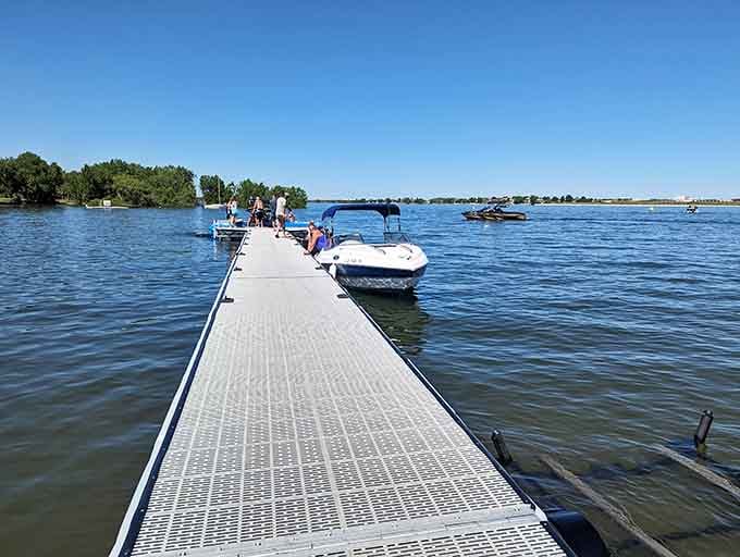 The boat dock stretches into blue water, providing easy lake access for watercraft of every size.
