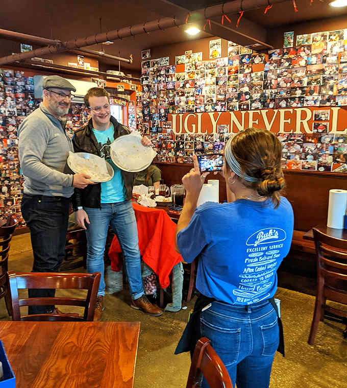 Staff members capture the moment of truth, documenting another brave soul's journey into burger immortality forever.