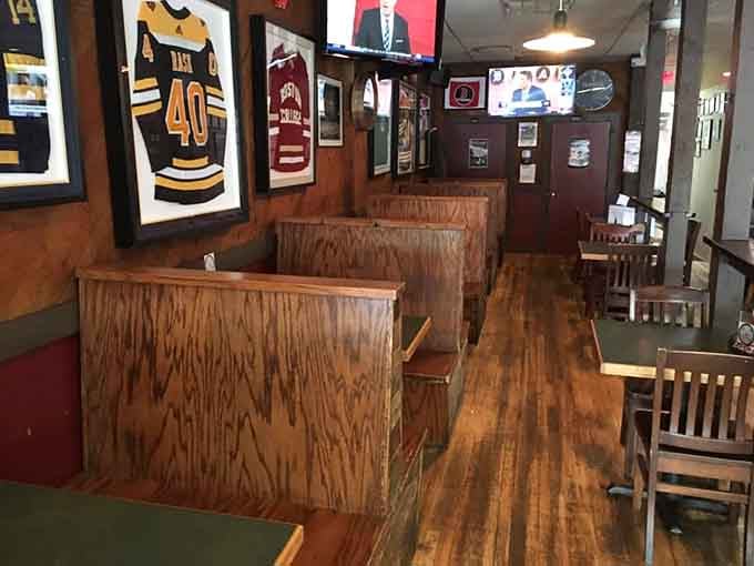 Framed jerseys and sports memorabilia line the walls, creating an authentic fan cave atmosphere throughout the space.