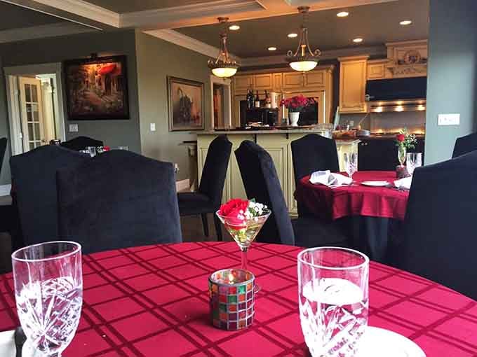 Red tablecloths and elegant place settings create an atmosphere where celebrations feel naturally at home here.