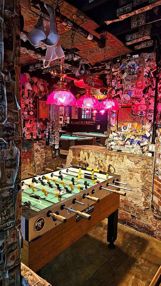 Foosball and pool tables provide entertainment for the living while the dead presumably watch from the rafters.