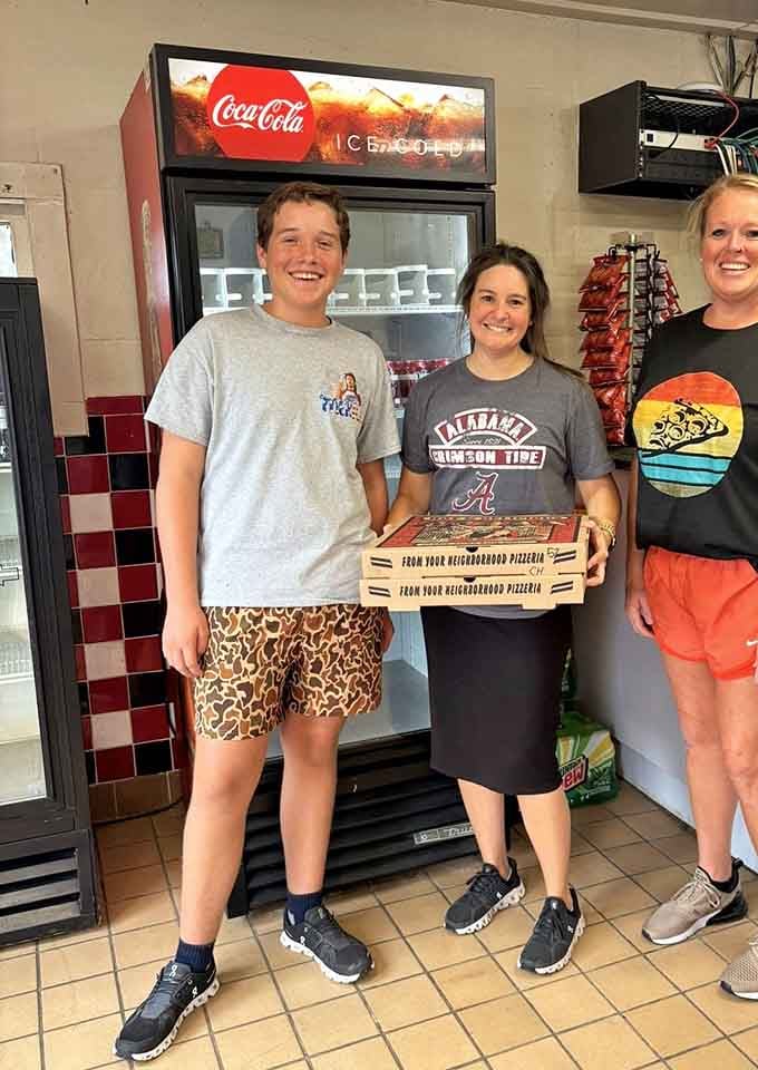 Happy customers clutching their pizza boxes like they've just won the Alabama lottery, and honestly, they kind of have.