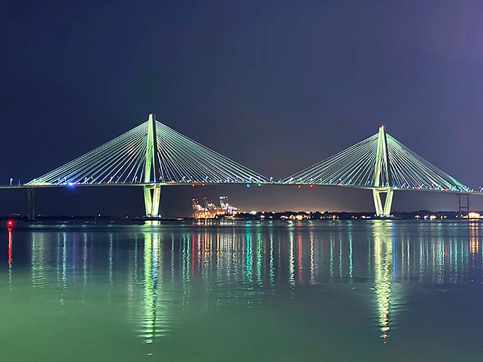 The Ravenel Bridge illuminates Charleston Harbor like a modern sculpture connecting past and present beautifully.