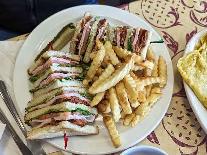 A triple-decker club sandwich that's engineered as precisely as the planes outside, served with perfectly crispy fries.