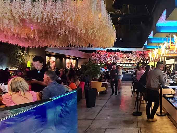 The dining room fills with happy guests beneath those famous blossoms, proving good design attracts good company every single time.