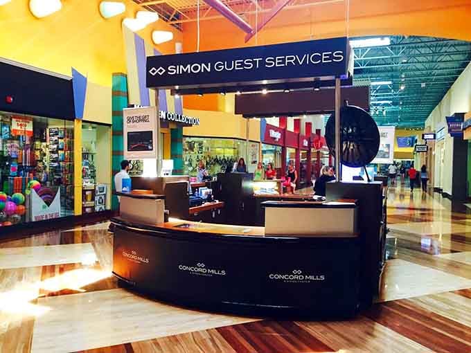 The guest services desk stands ready to help navigate your shopping adventure like a friendly neighborhood concierge.