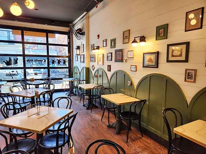 The framed pictures and warm lighting create an atmosphere that feels like dining in your coolest friend's home.