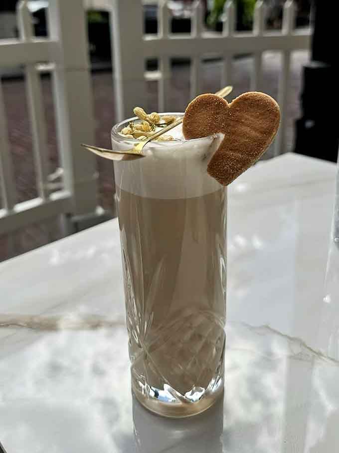 Heart-shaped cookie garnish on your latte because apparently even your coffee deserves a little romance this morning here.
