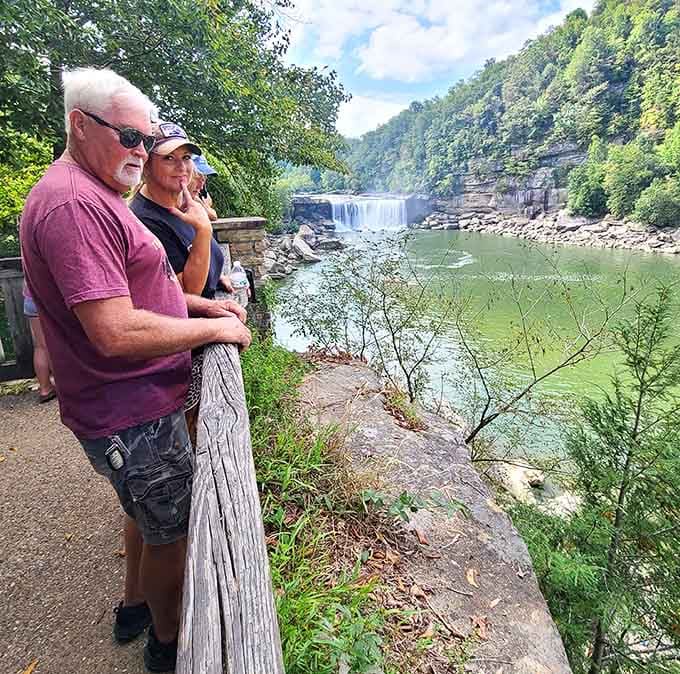 Three generations soaking in the same waterfall view, proving some experiences never get old no matter how many times you visit.