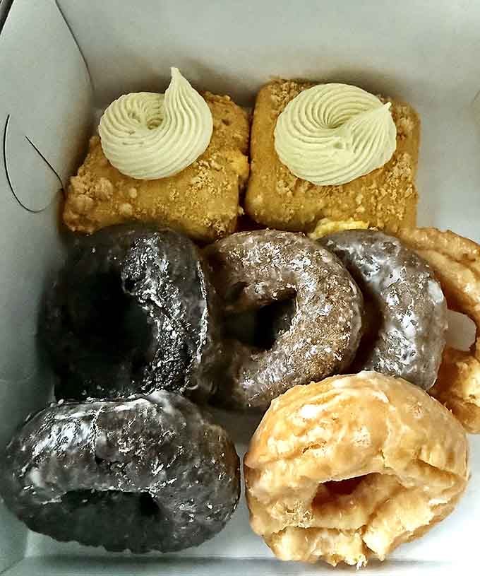 A donut assortment that looks like it fell straight from heaven into this blessed box of carbs.