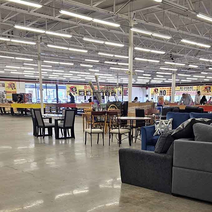 Dining sets and furniture spread across the warehouse floor like an indoor yard sale, minus the awkward haggling.