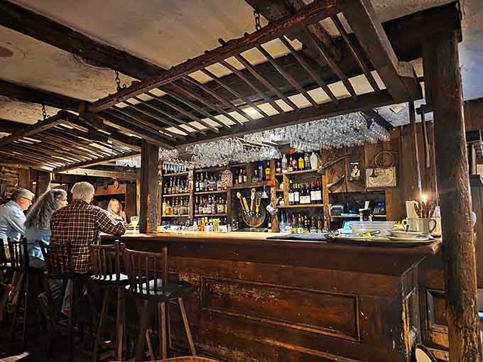 The bar area features exposed beams and stone that make you want to order something colonial.