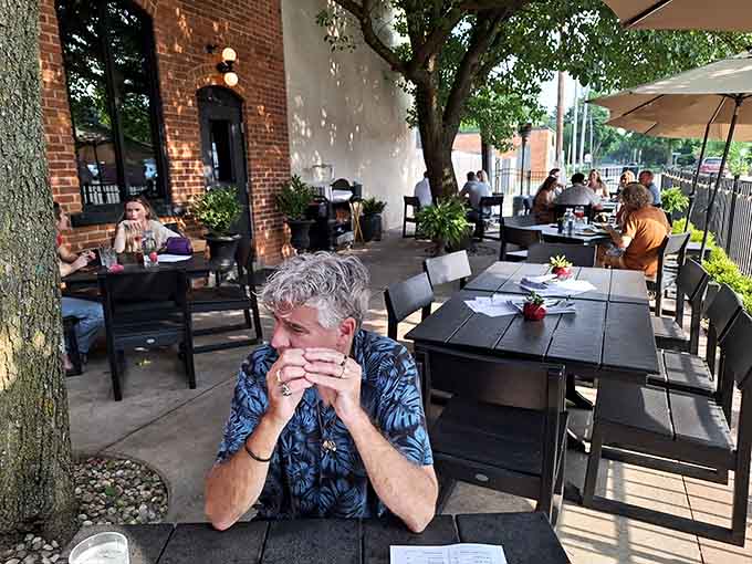 Outdoor dining under the trees, because sometimes the best seat in the house is actually outside it.