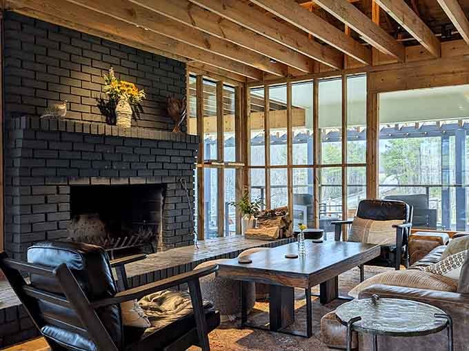 A stone fireplace anchored by leather chairs creates the kind of cozy corner where time slows down considerably.