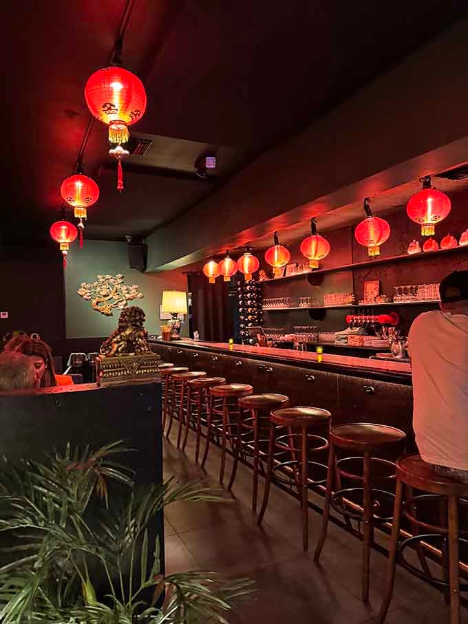 The bar area glows with red lanterns and promises of cocktails that'll transport you somewhere between Beijing and Miami Beach.
