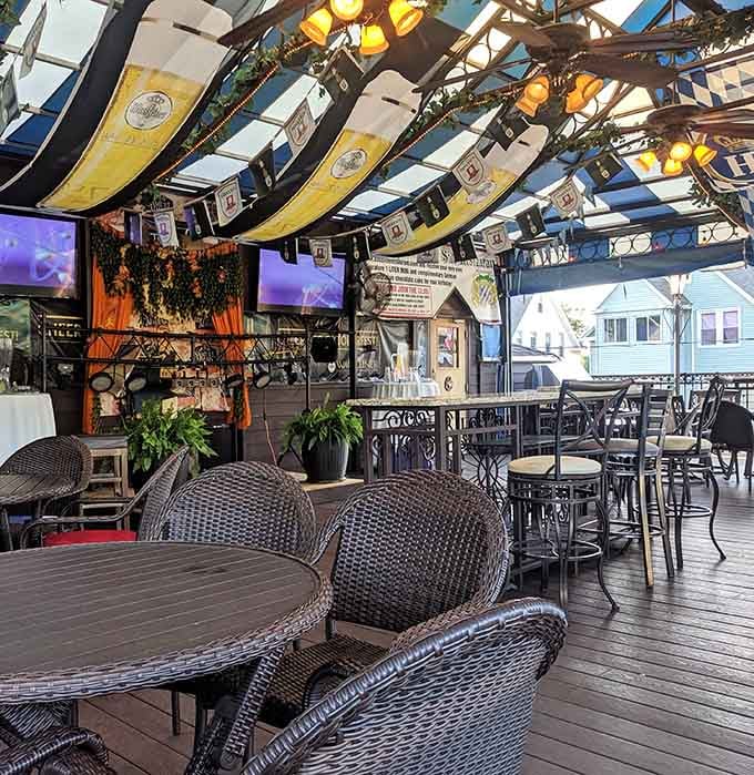 The outdoor beer garden with Bavarian flags flying overhead, perfect for pretending you're actually in Munich.