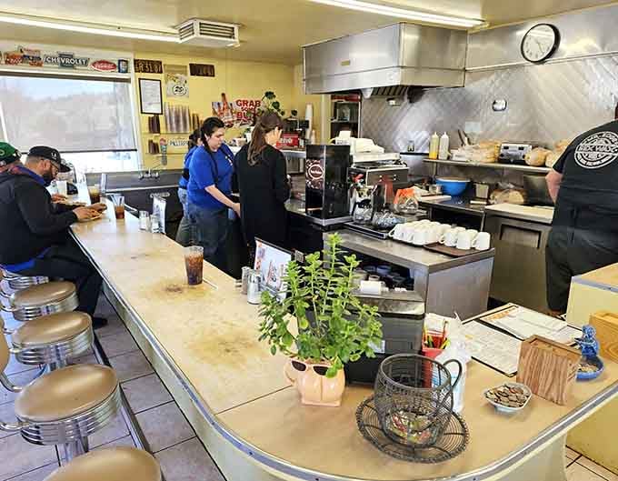 The crew behind the counter moves with the practiced efficiency of people who've flipped a million burgers.