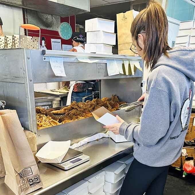 Fresh chicken being packed into boxes by hand is how you know this place takes pride in everything.