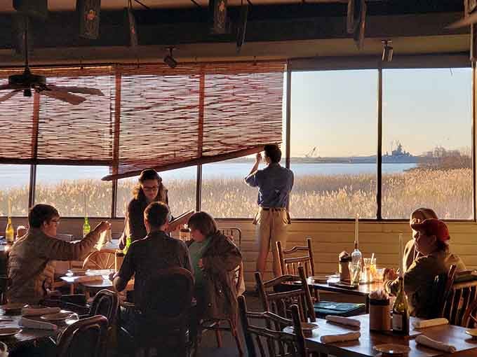 Golden hour through those massive windows turns dinner into dinner theater, with Mobile Bay providing the spectacular performance nightly.