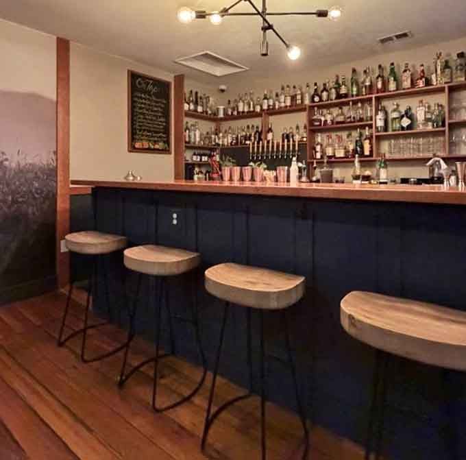 The bar area where solo diners feel welcome and cocktails get the same attention as entrees.