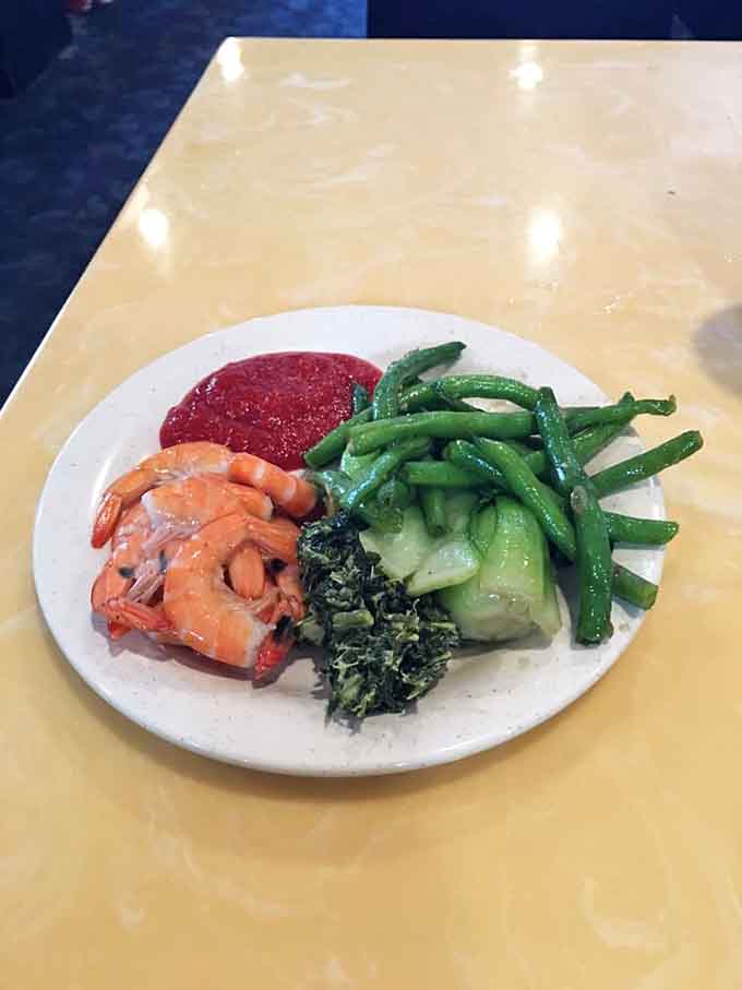 Shrimp and greens arranged like someone actually cares about presentation, even when you're getting unlimited refills and seconds.