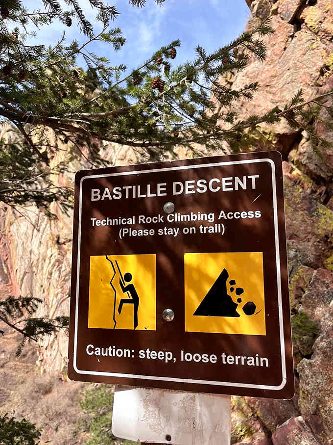 The Bastille Descent sign warns of steep terrain ahead, like a friendly bouncer at nature's exclusive club.