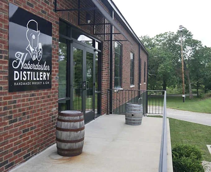 Those whiskey barrels flanking the entrance promise handcrafted spirits worth savoring, not just shooting on a dare.