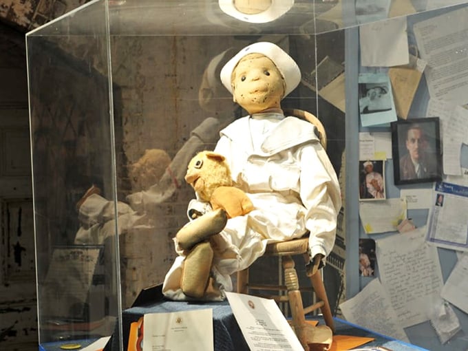 Robert the Doll sits behind glass like Hannibal Lecter, which honestly feels like appropriate precautions for this infamous resident.