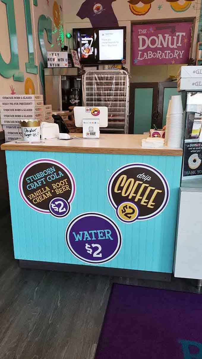 The turquoise counter and cheerful signage make ordering feel less like a transaction and more like joining a celebration.