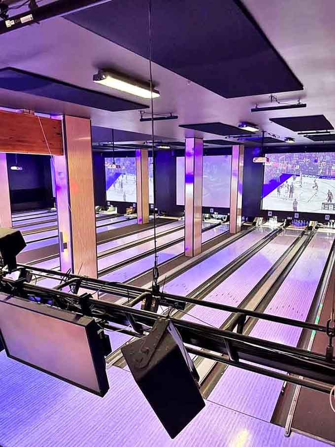 Purple mood lighting transforms these modern lanes into something from a sci-fi movie where everyone bowls in style.