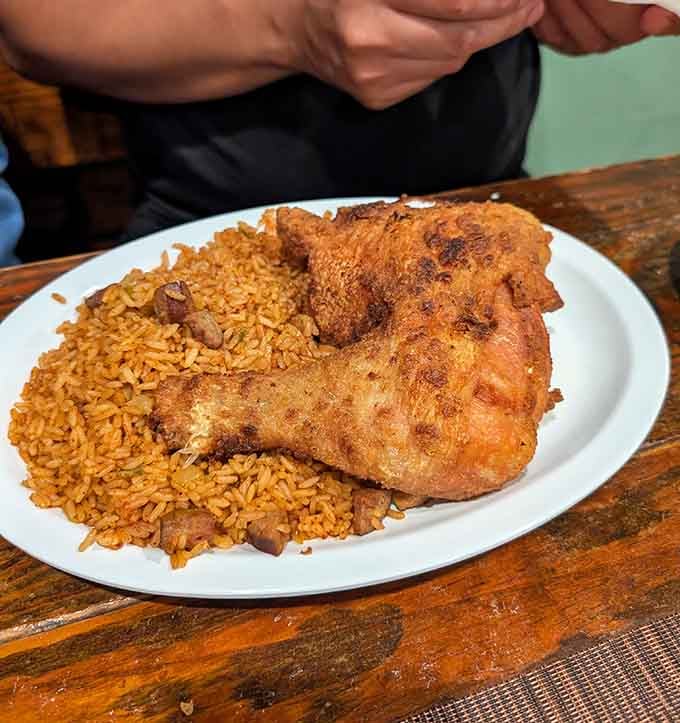 Fried chicken perched atop red rice creates a mountain of Southern comfort worth climbing.