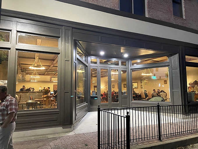 Evening light through those windows reveals the simple truth: good food brings people together, no reservations required.